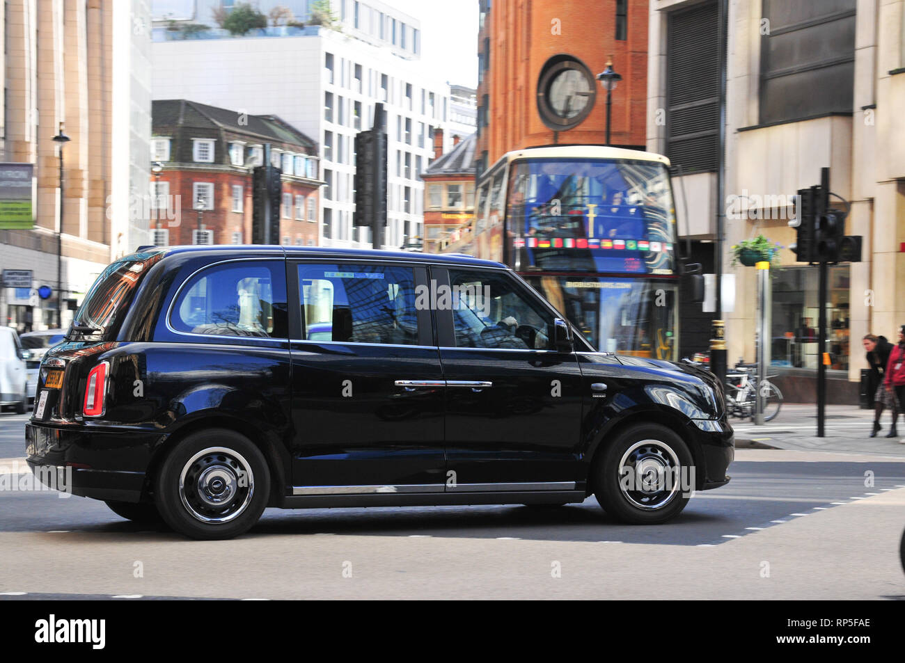 New LEVC TX taxi, black cab, driving on the streets of London Stock ...