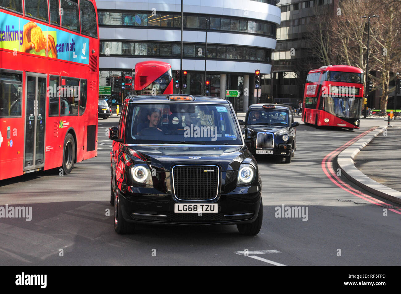 New LEVC TX taxi, black cab, driving on the streets of London Stock ...