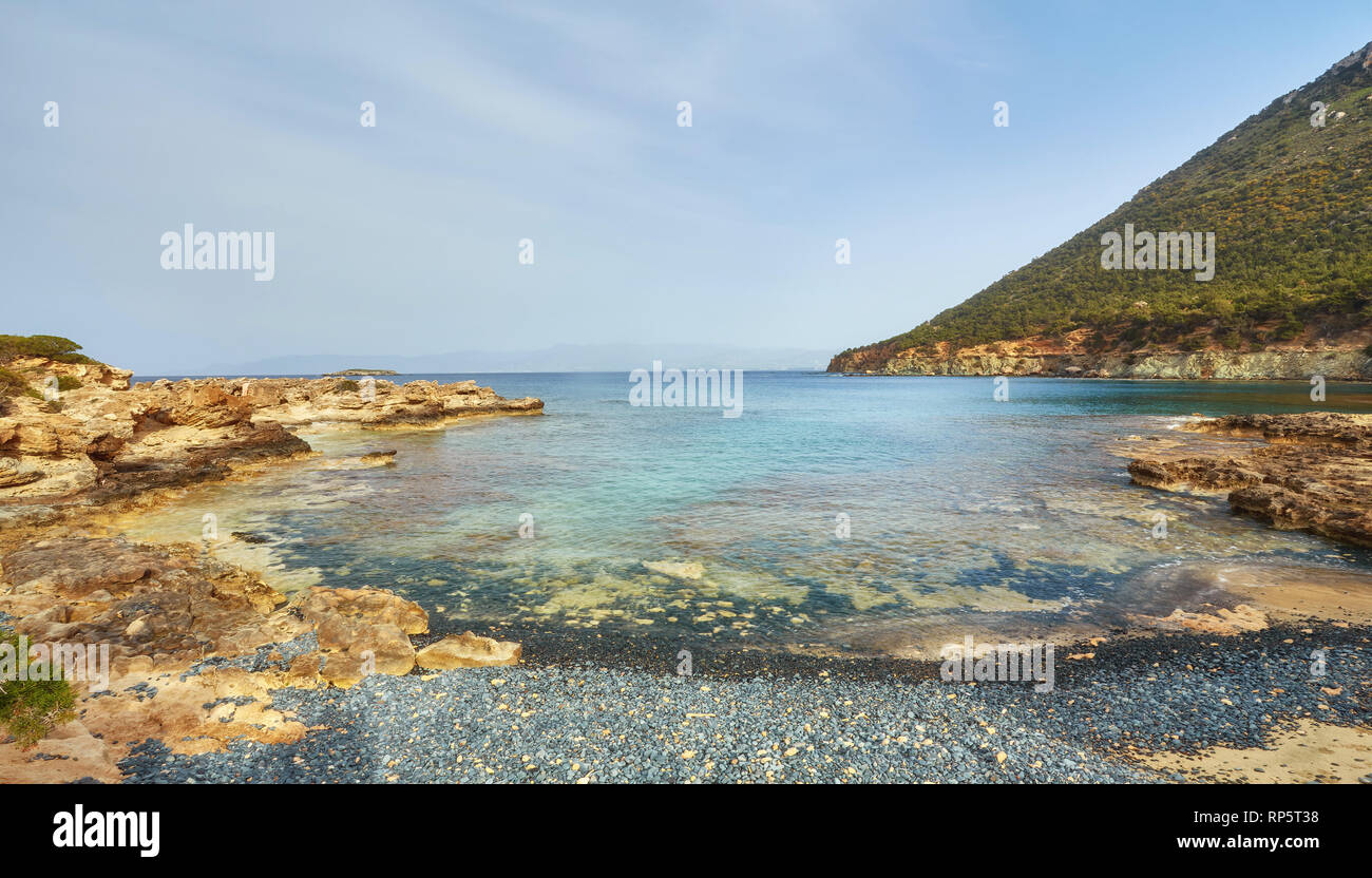 Stones and rocks in forefront with creamy surf ebbing and flowing on ...