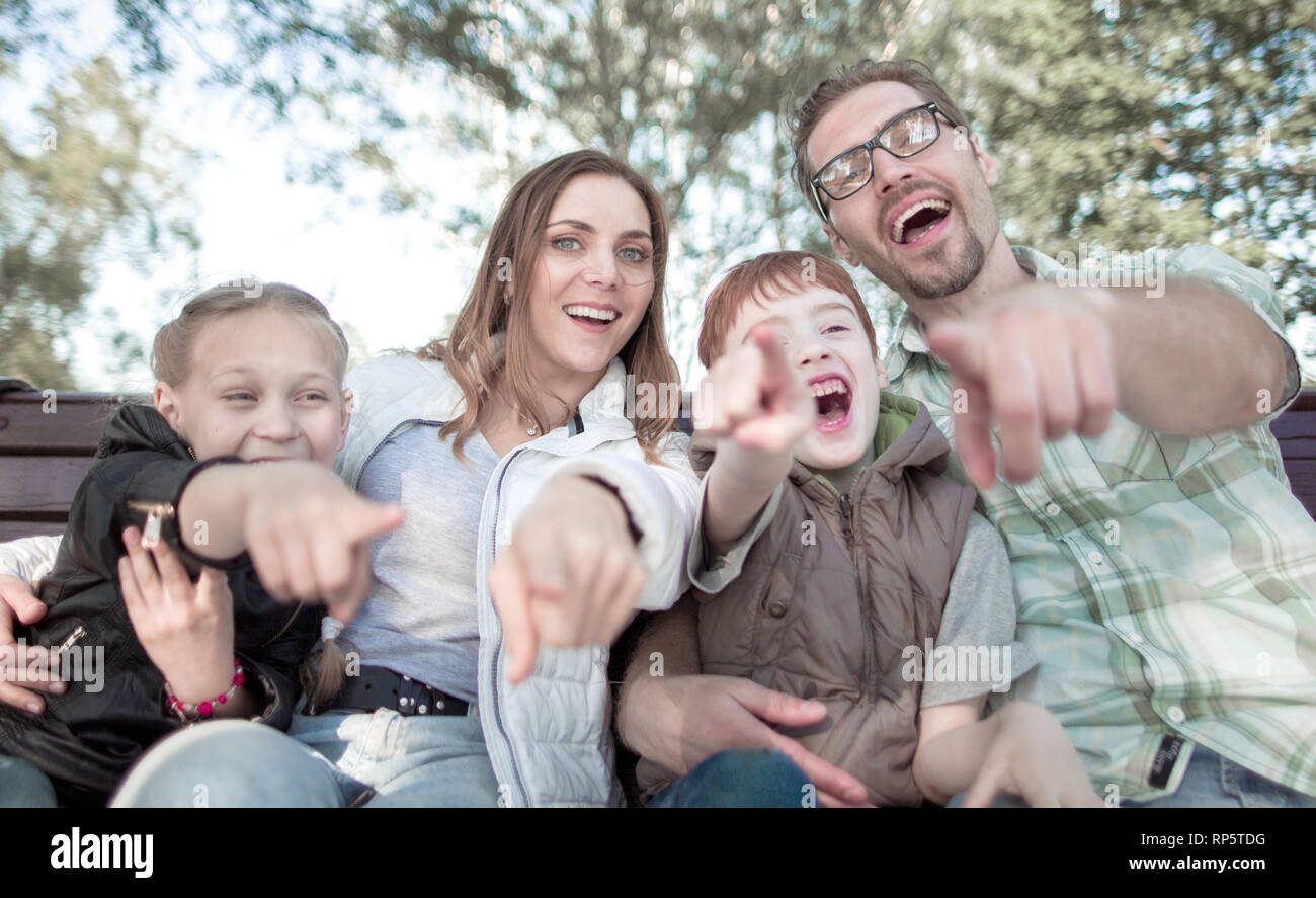 close up.parents with two kids pointing at you Stock Photo - Alamy