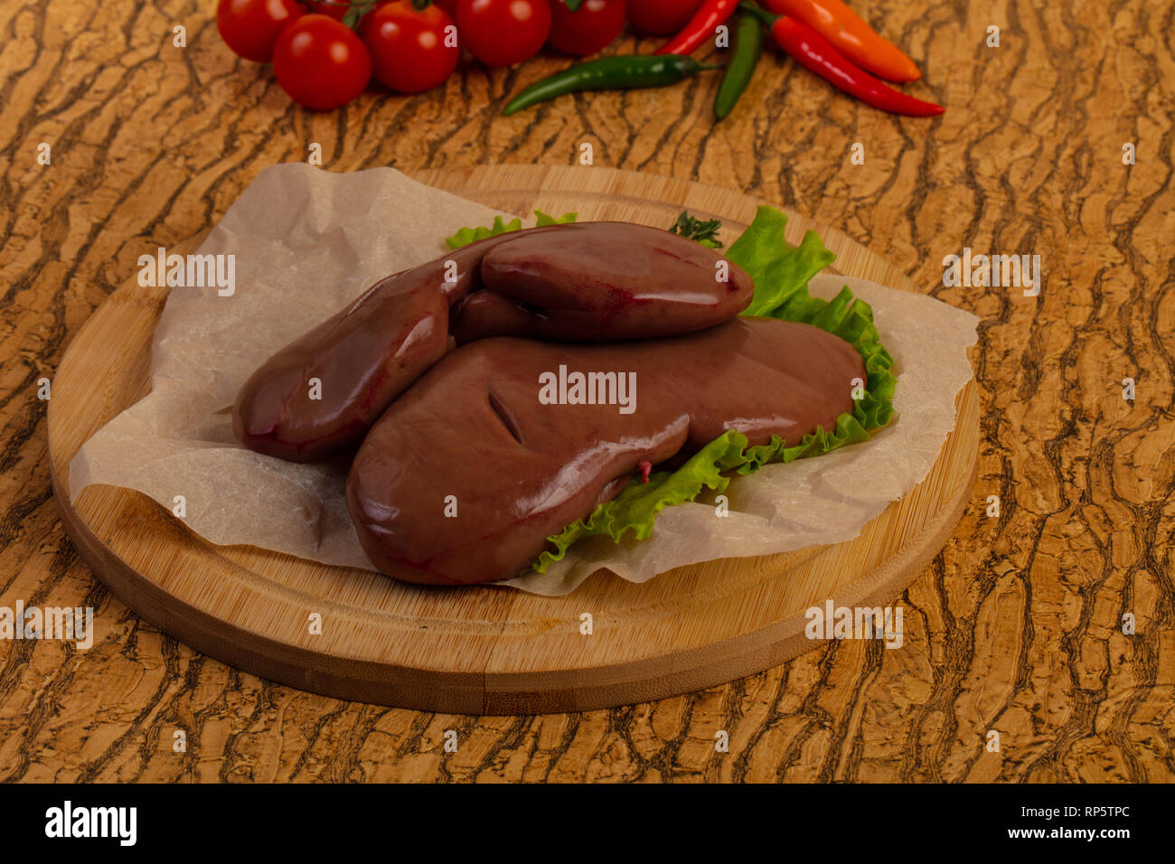 Raw pork kidneys ower wooden background Stock Photo - Alamy
