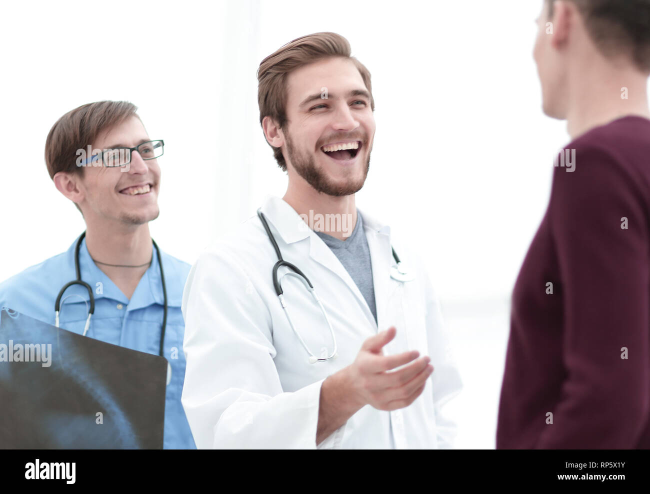 happy doctors with x-ray of the patient Stock Photo - Alamy
