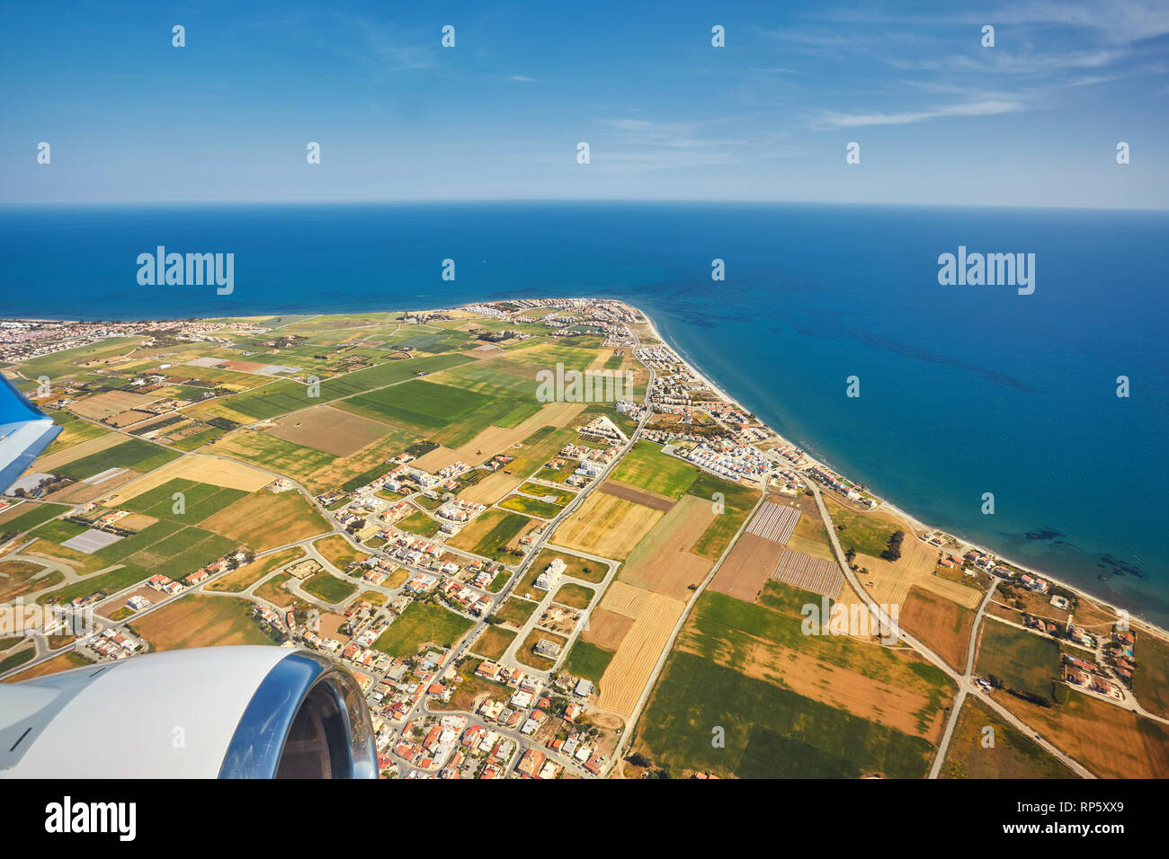 The plane is flying over the island of Cyprus. Airplane wing in flight ...