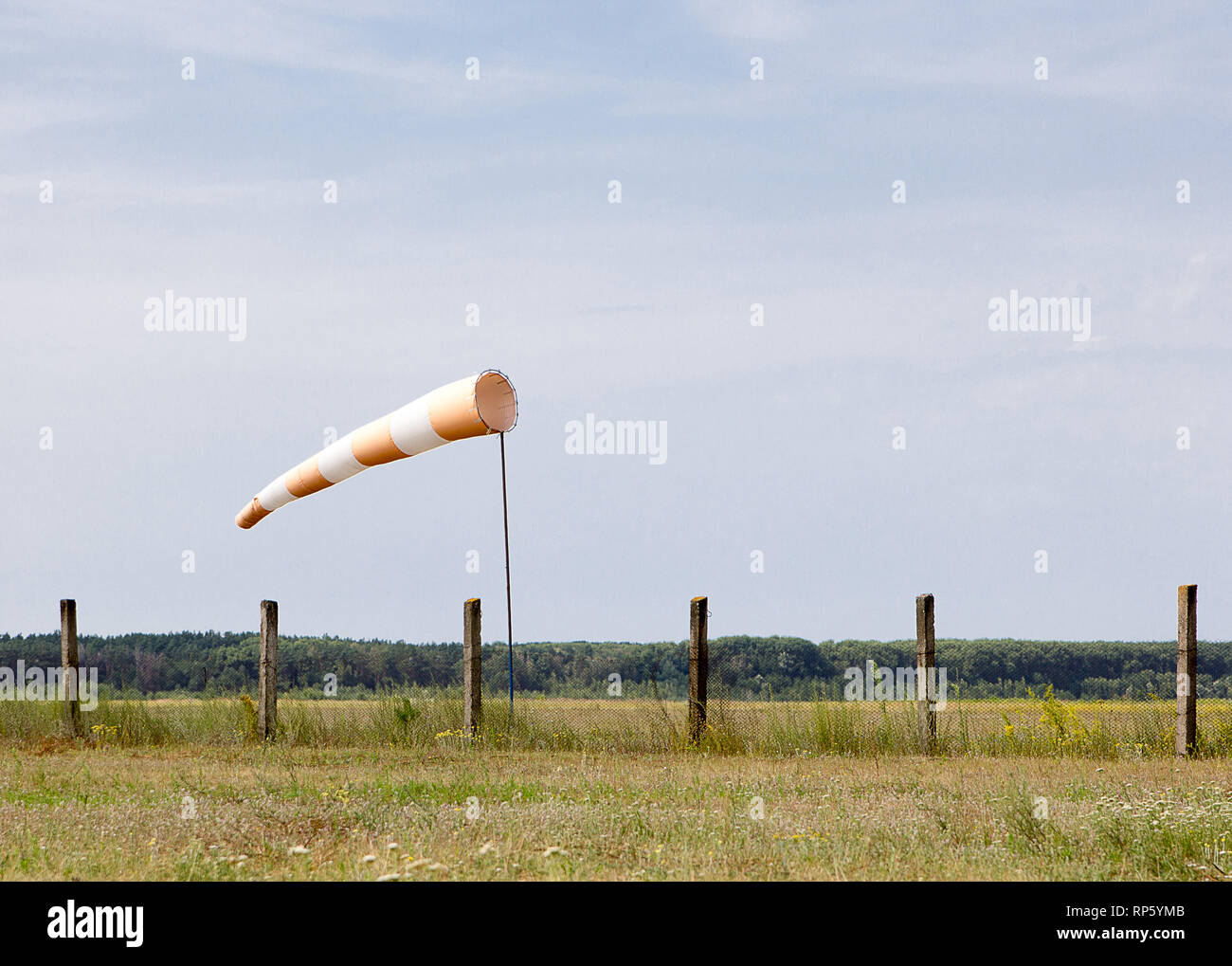 Red-white windsock indicating wind with blue sky at the airfield Stock ...