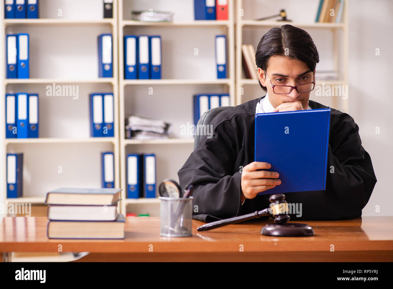 Young handsome judge working in court Stock Photo - Alamy