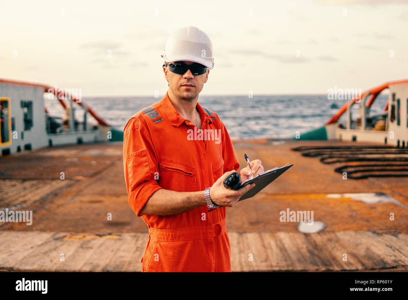 chief officer on deck of ship or vessel with checklist Stock Photo - Alamy