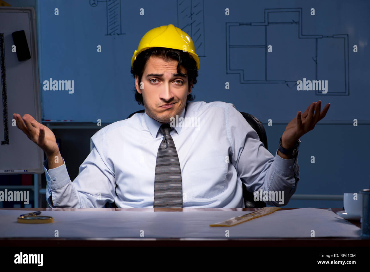 Young construction architect working on project at night Stock Photo ...