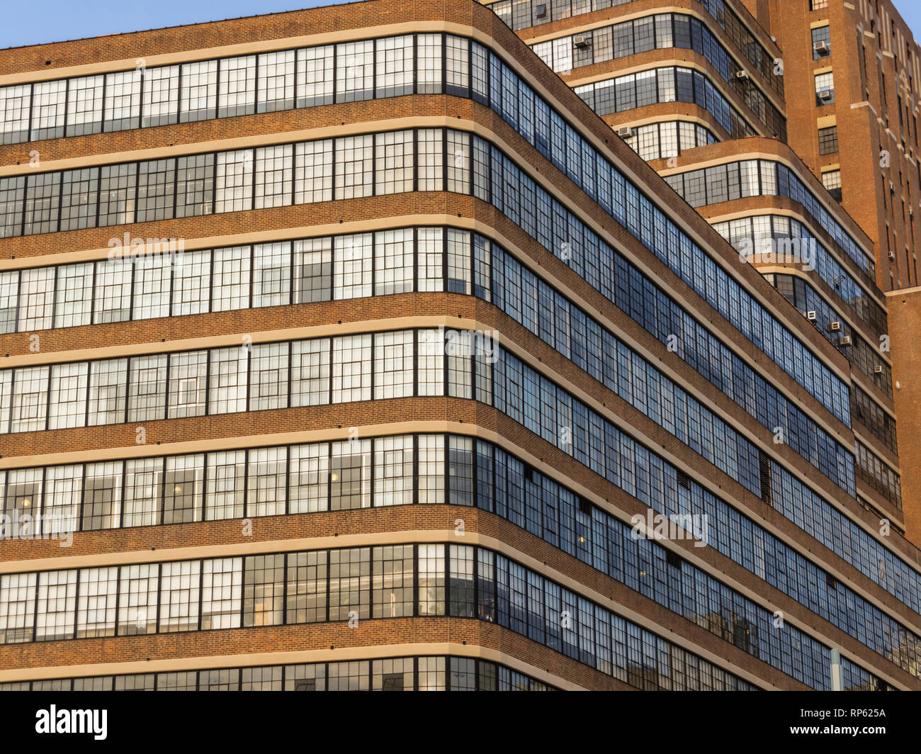 Corner with pattern of windows on front and side of building Stock ...