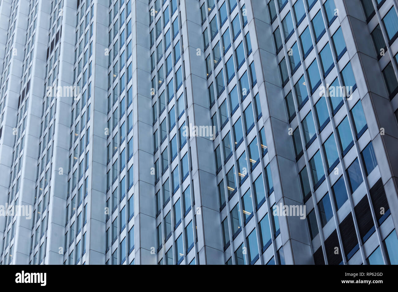Pattern of blue windows on tall office building in lower Manhattan ...