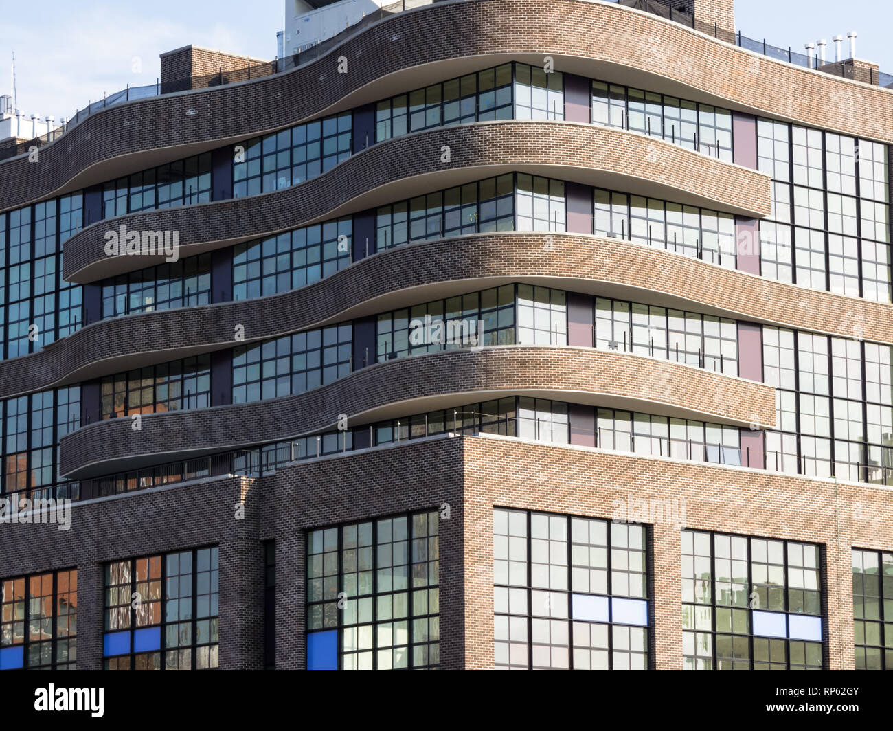 Rounded corner on an office building in New York City with balconies ...
