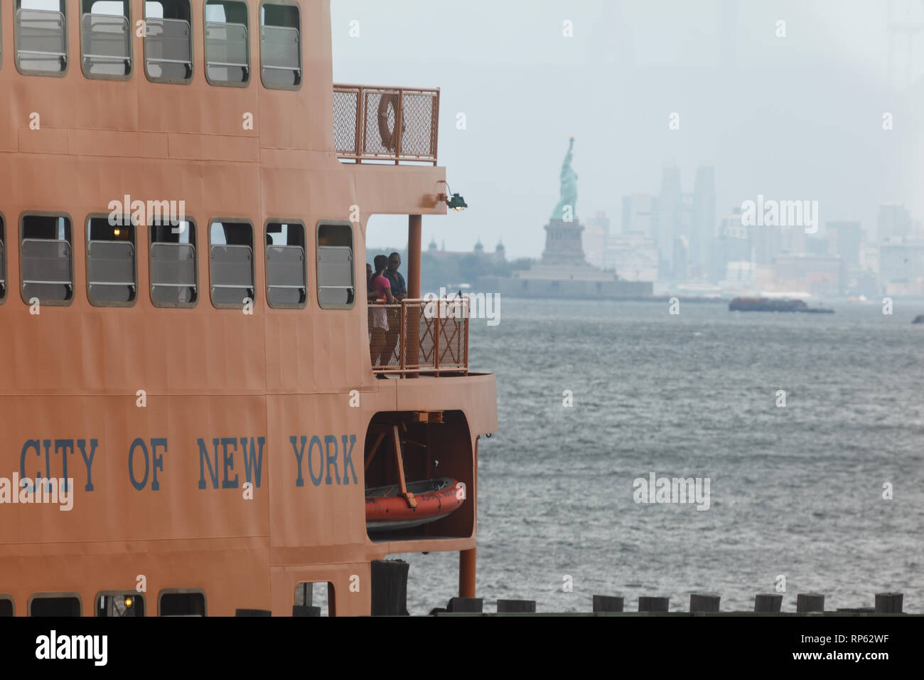 New York passenger ferry crosses harbor past Statue of Liberty ...