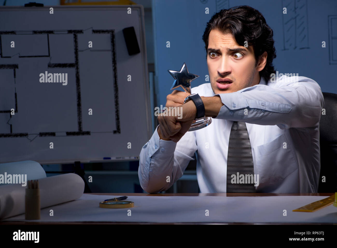 Young construction architect working on project at night Stock Photo ...
