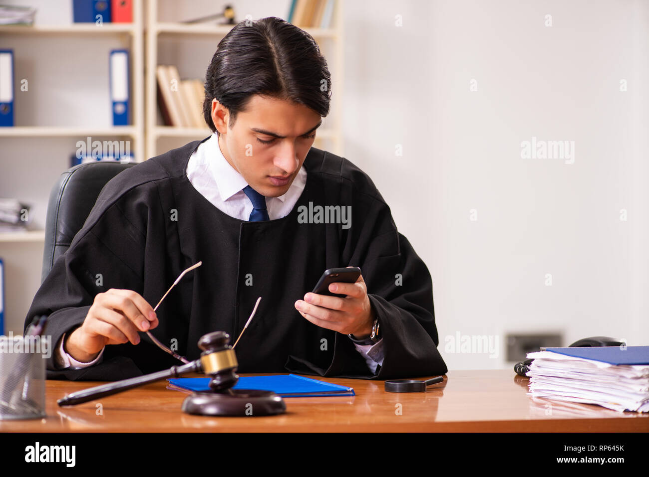 Young handsome judge working in court Stock Photo - Alamy