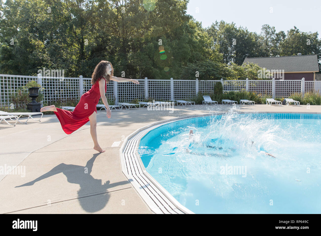 A young couple goofing around by a pool Stock Photo - Alamy
