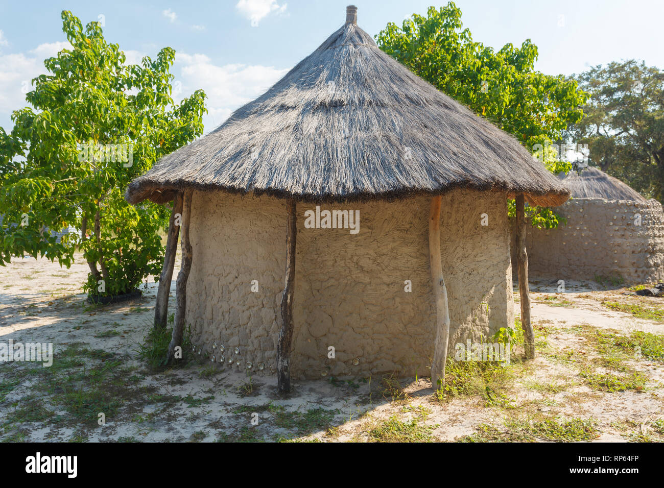 Closeup of traditional round mud hut with thatched roof of natives of ...