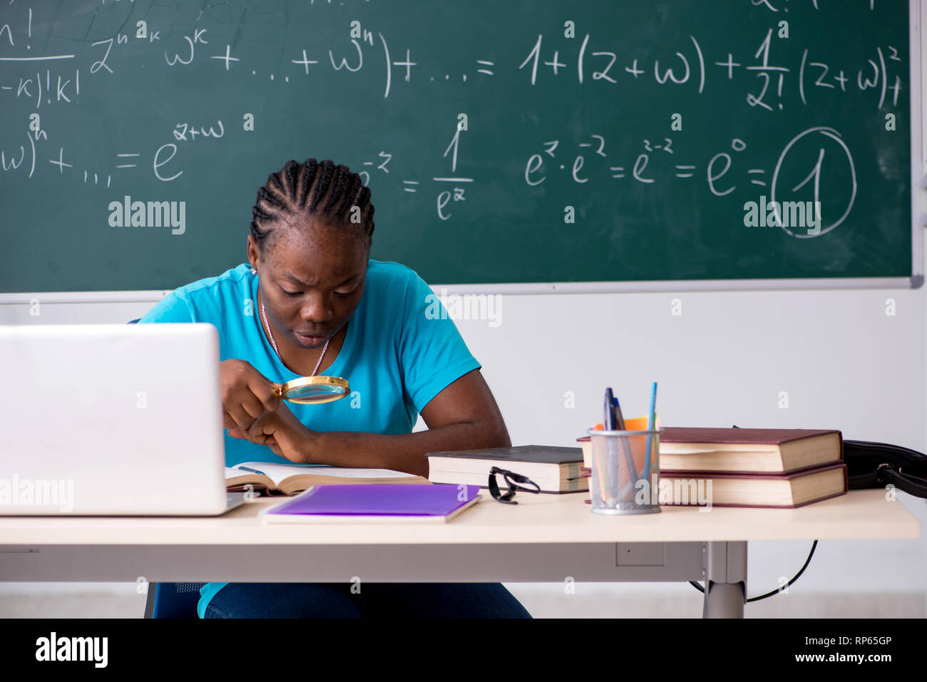 Black female student in front of chalkboard Stock Photo - Alamy