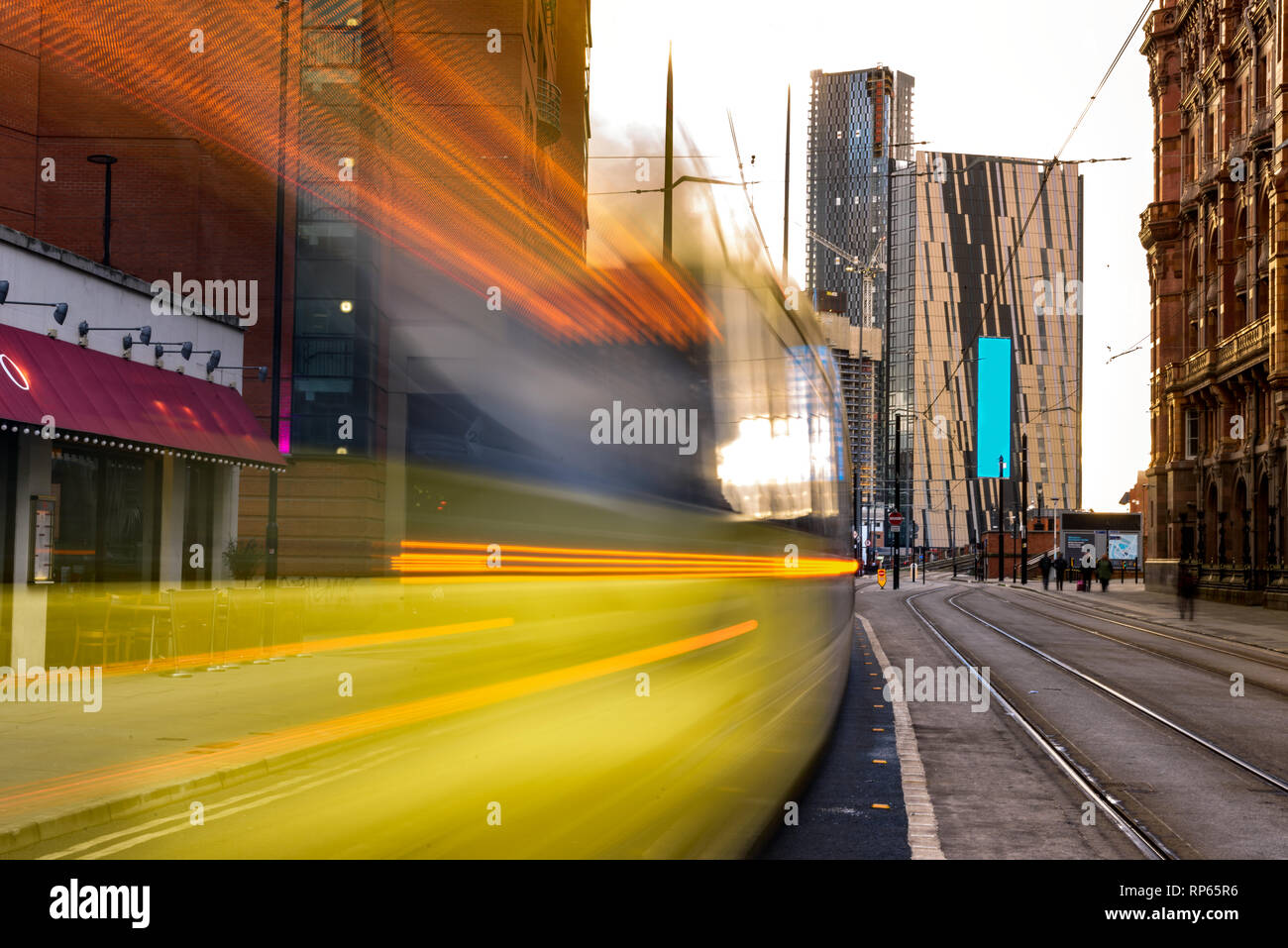 Light rail yellow tram in the city center of Manchester, UK in the ...
