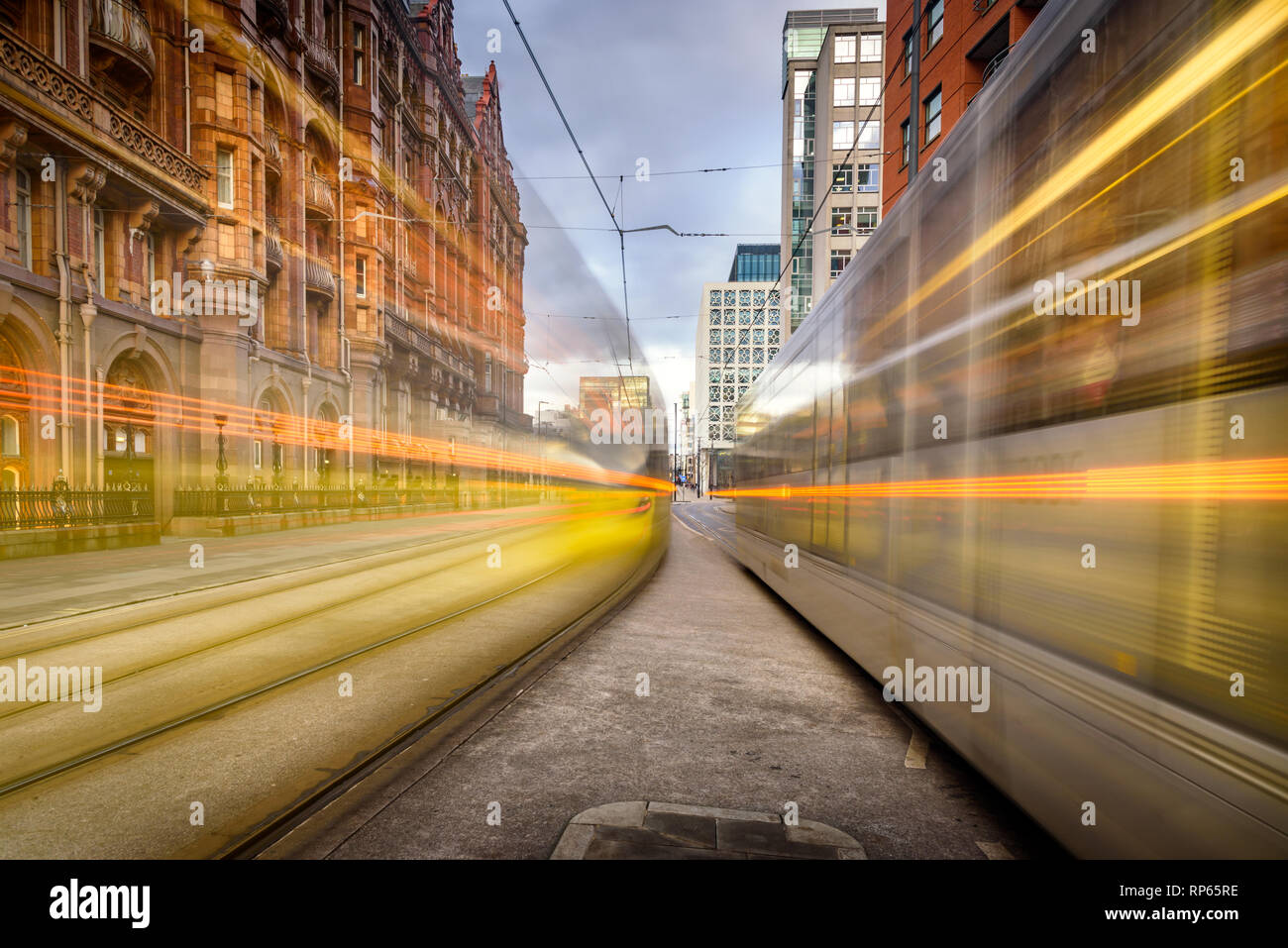 Yellow fast moving Metrolink tram in Manchester City Stock Photo - Alamy