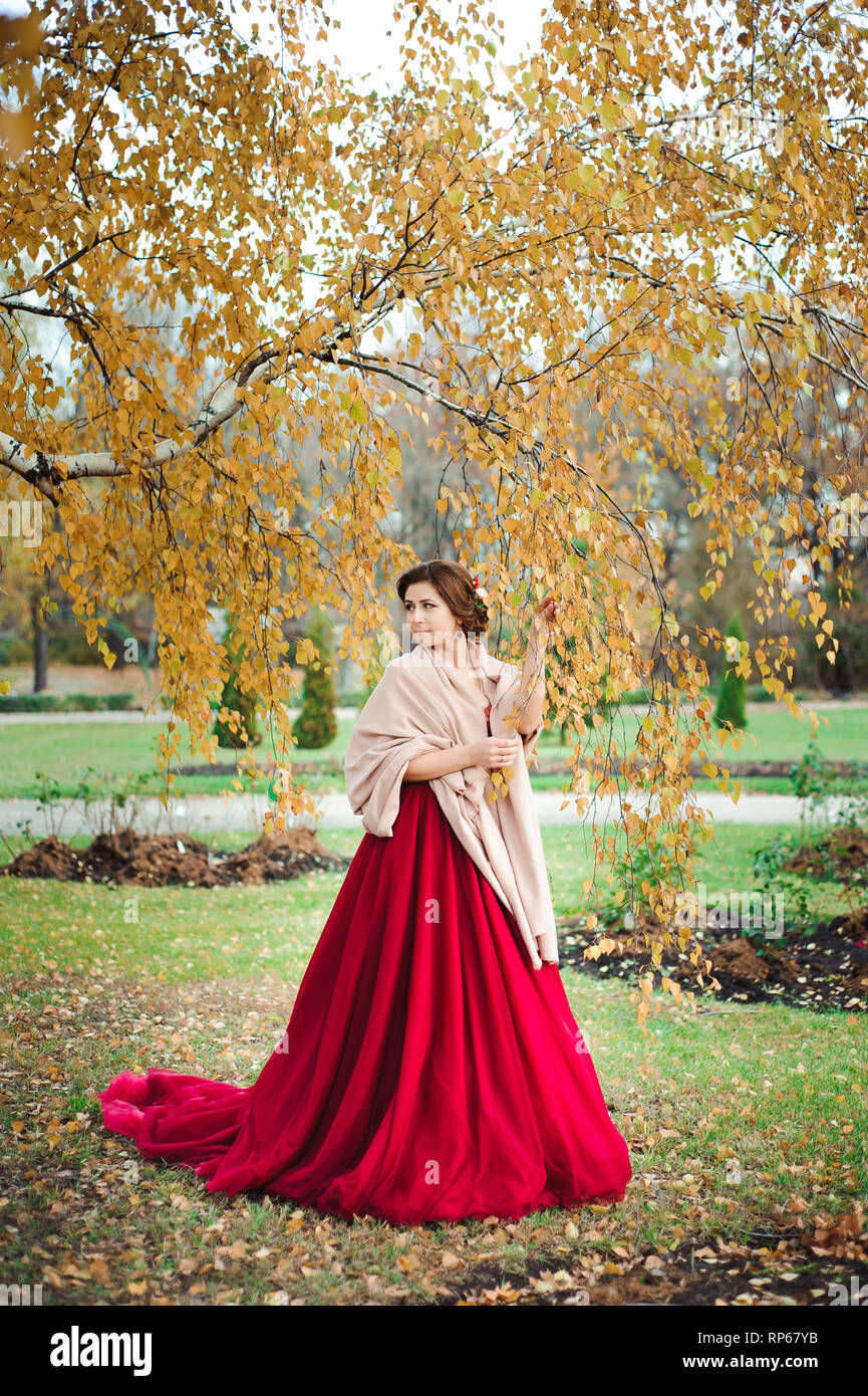 beautiful girl in a red dress in the autumn forest Stock Photo - Alamy
