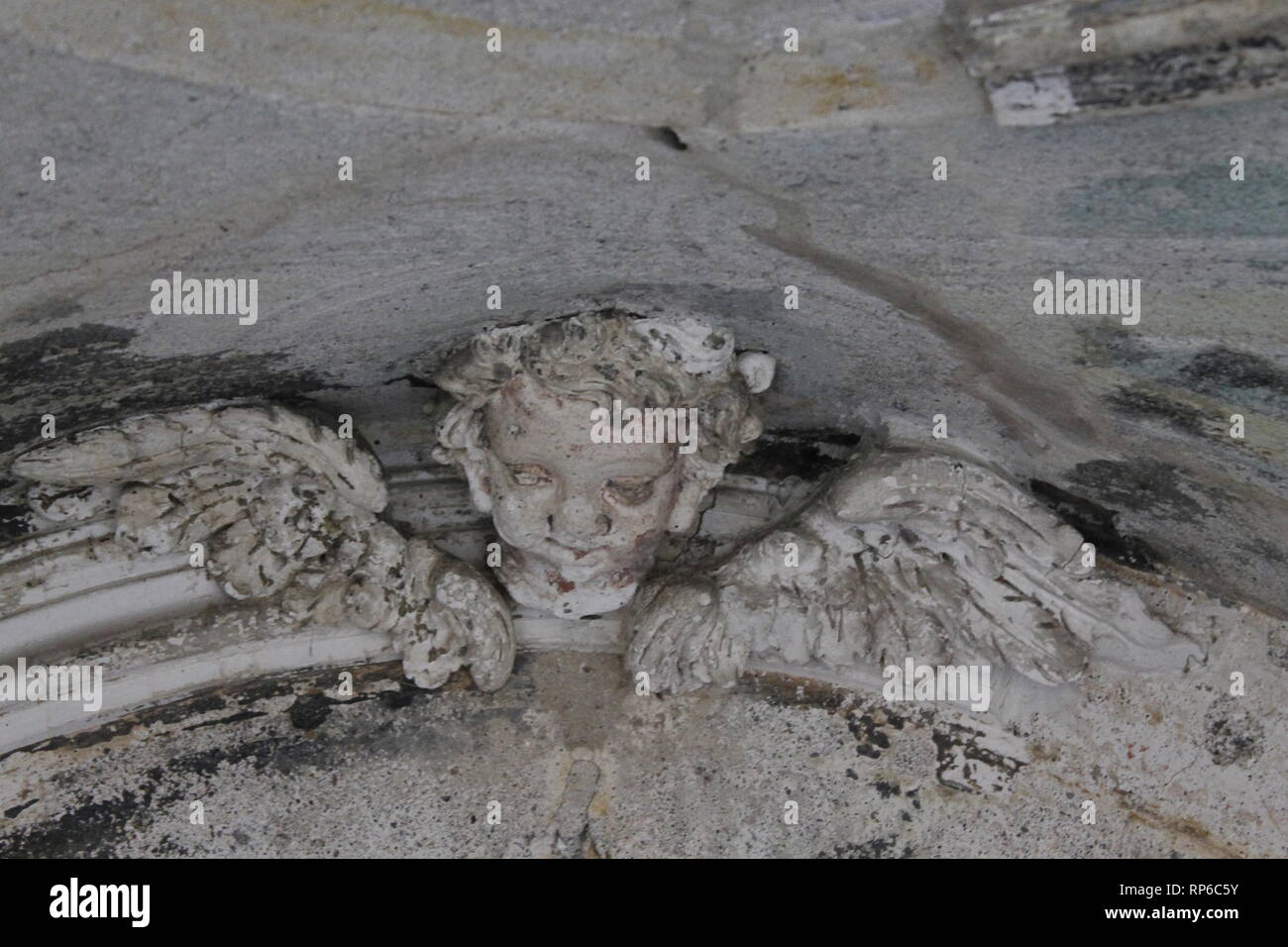 close up of ancient stone angel statue in an ancient chapel in Italy ...