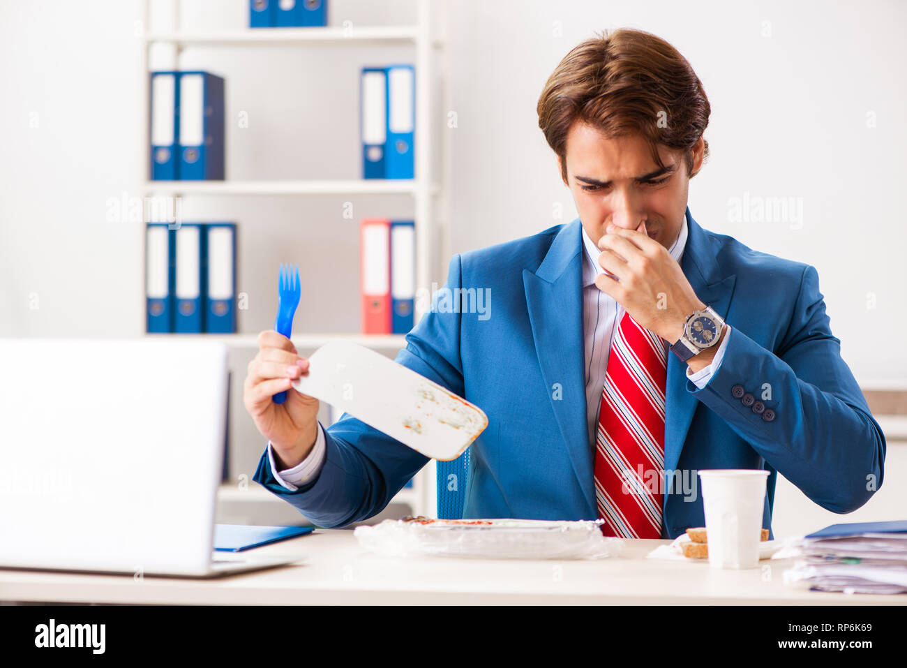 Man having meal at work during break Stock Photo - Alamy