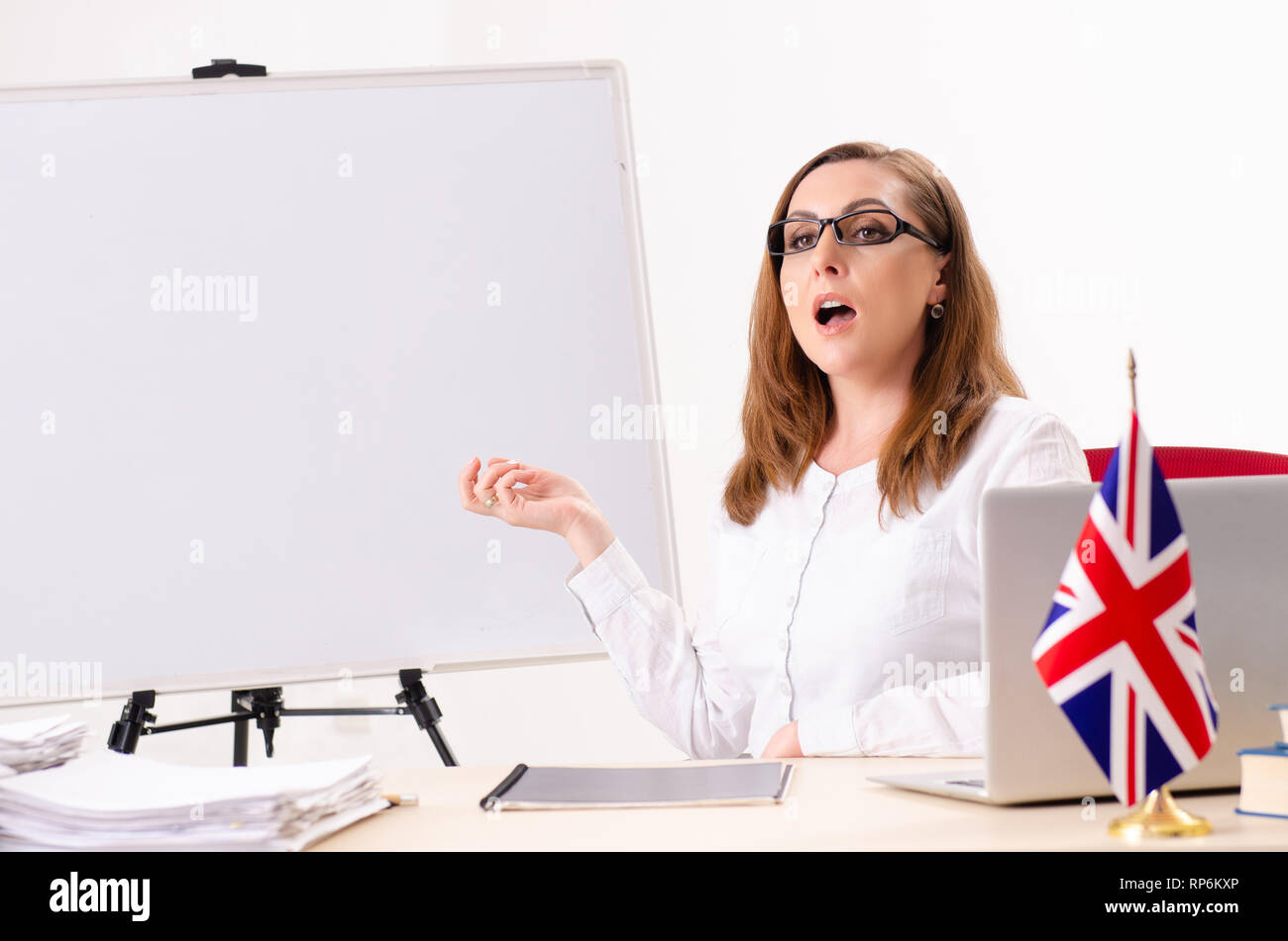 Female english teacher in the classroom Stock Photo - Alamy