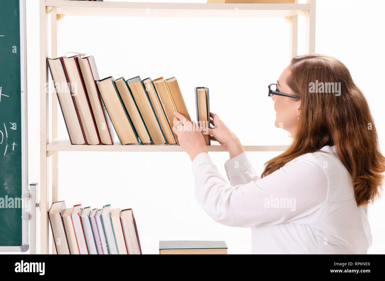 Female math teacher in the classroom Stock Photo - Alamy