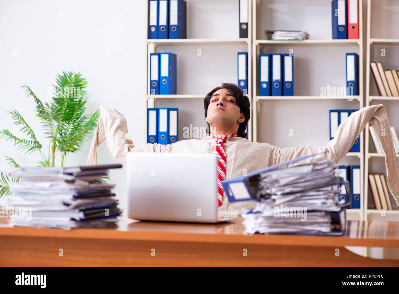 Crazy young man in straitjacket at the office Stock Photo - Alamy