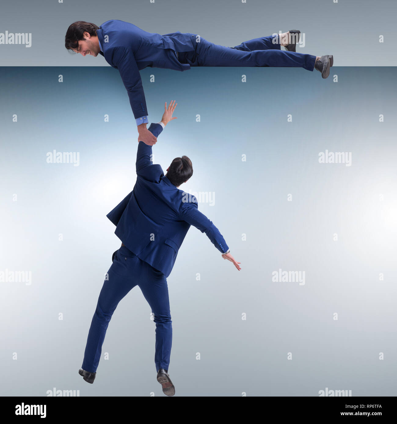Businessman pulling falling hi-res stock photography and images - Alamy