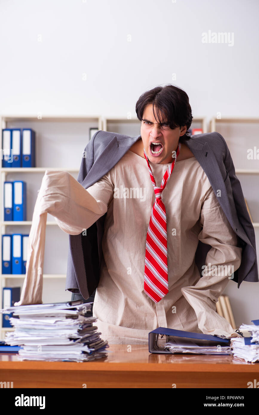 Crazy young man in straitjacket at the office Stock Photo - Alamy