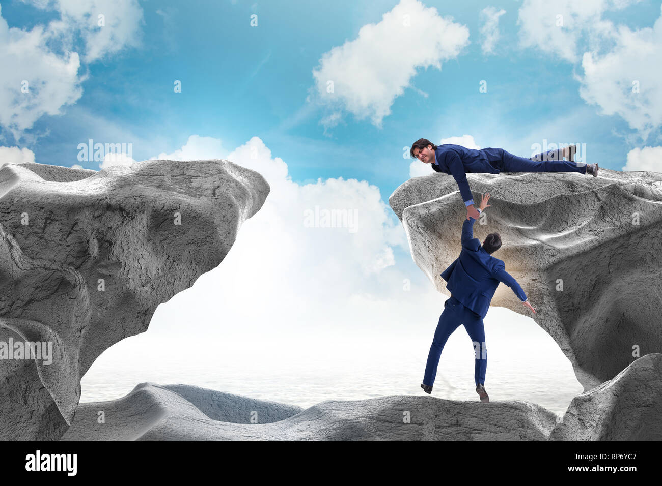 Businessman offering helping hand to falling colleague Stock Photo - Alamy