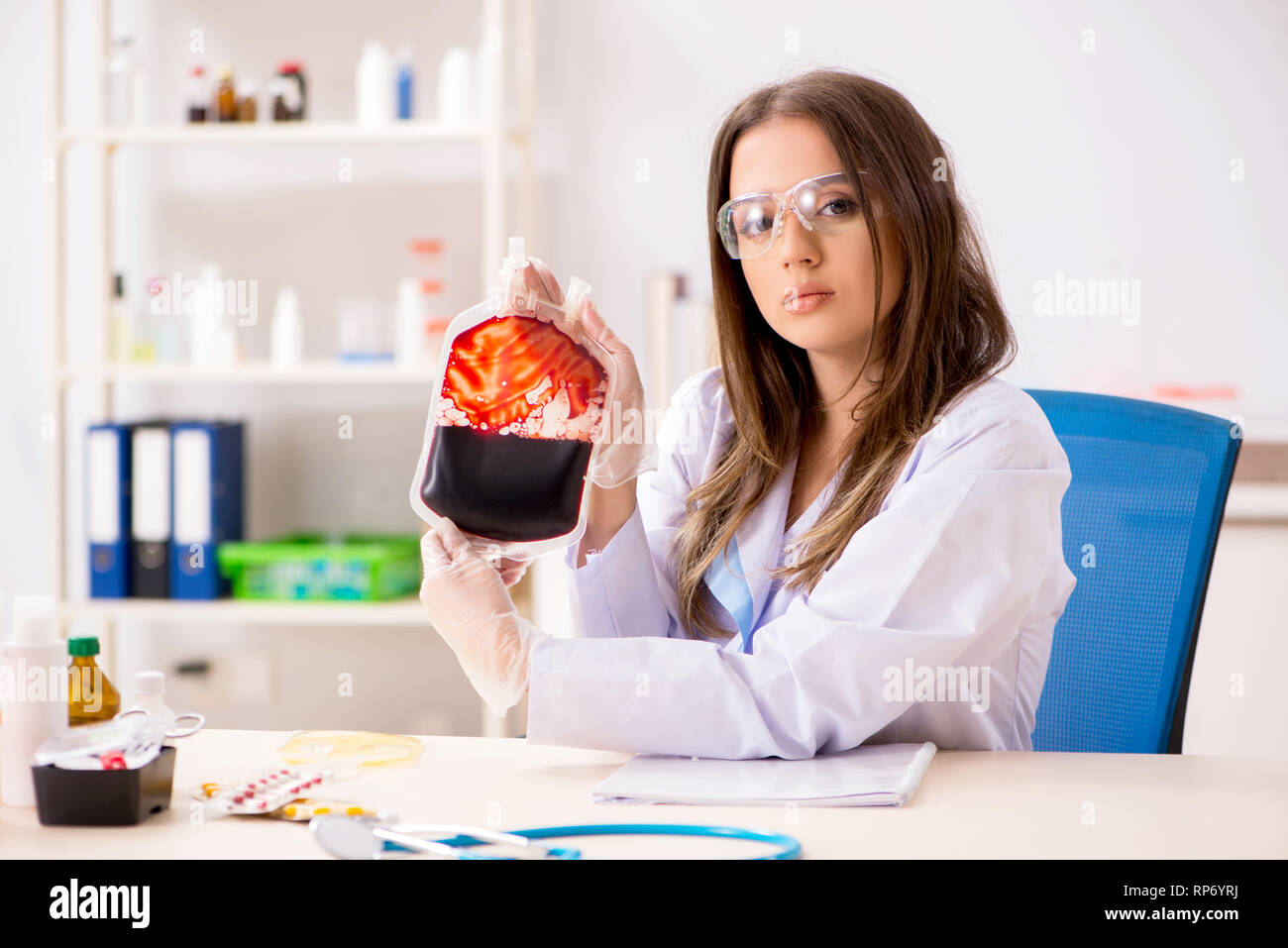 Female assistant with bag of blood in the lab Stock Photo - Alamy