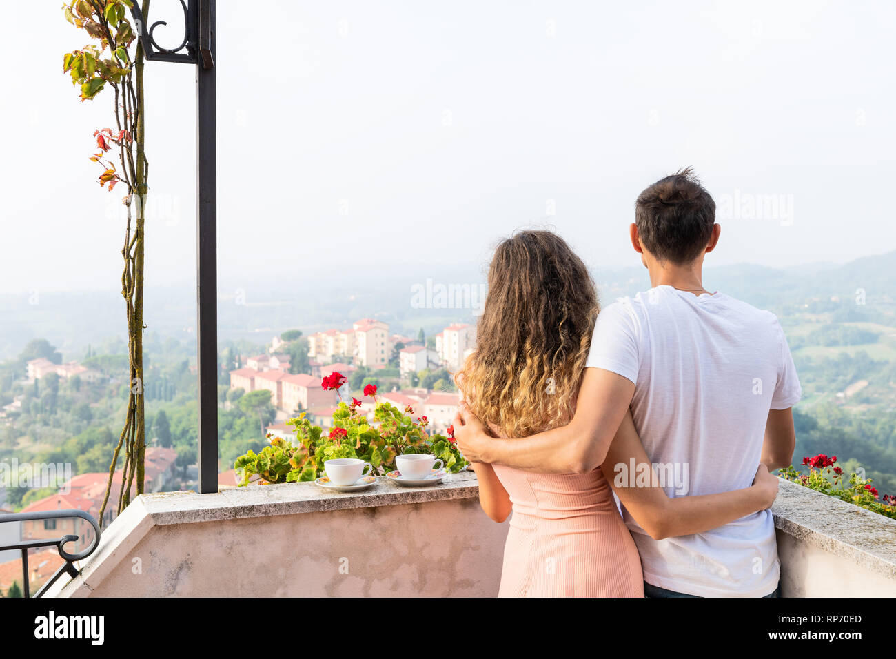 Woman and man romantic couple on terrace garden outside in Italy with ...