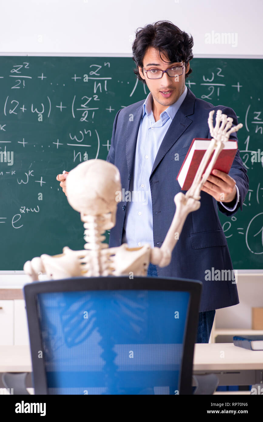 Young male math teacher and student skeleton Stock Photo - Alamy