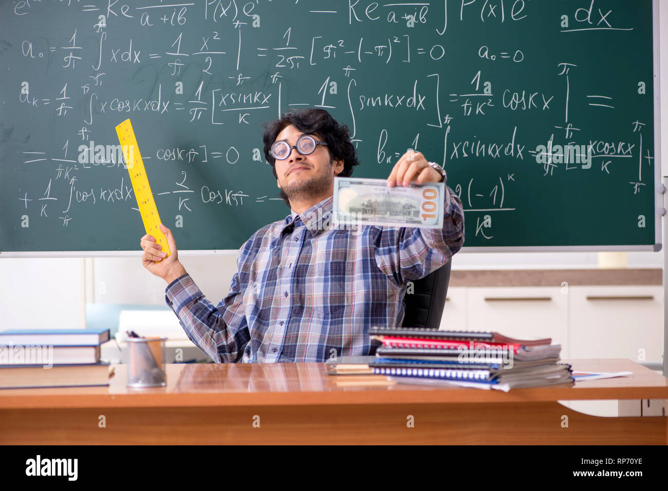 Funny male math teacher in the classroom Stock Photo - Alamy