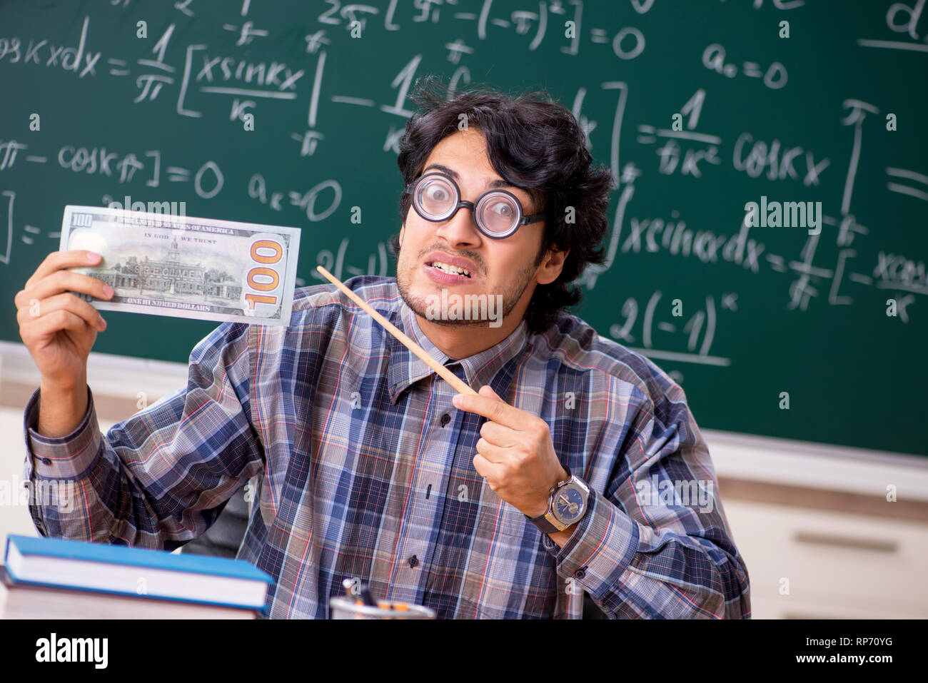 Funny male math teacher in the classroom Stock Photo - Alamy