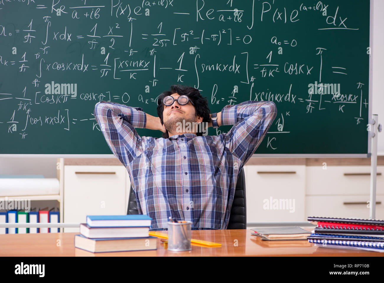 Funny male math teacher in the classroom Stock Photo - Alamy