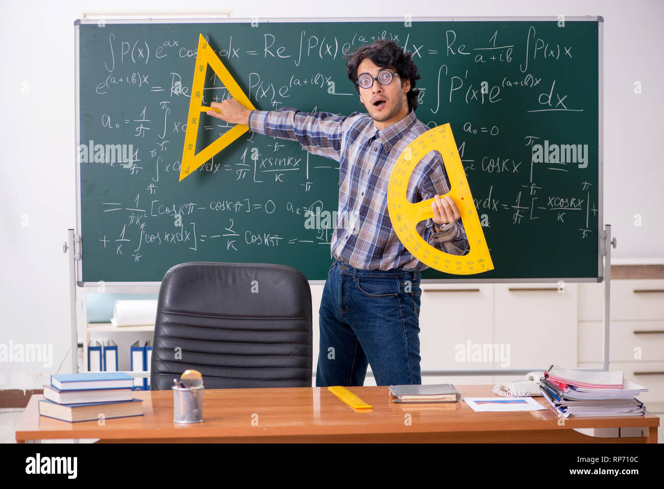 Funny male math teacher in the classroom Stock Photo - Alamy