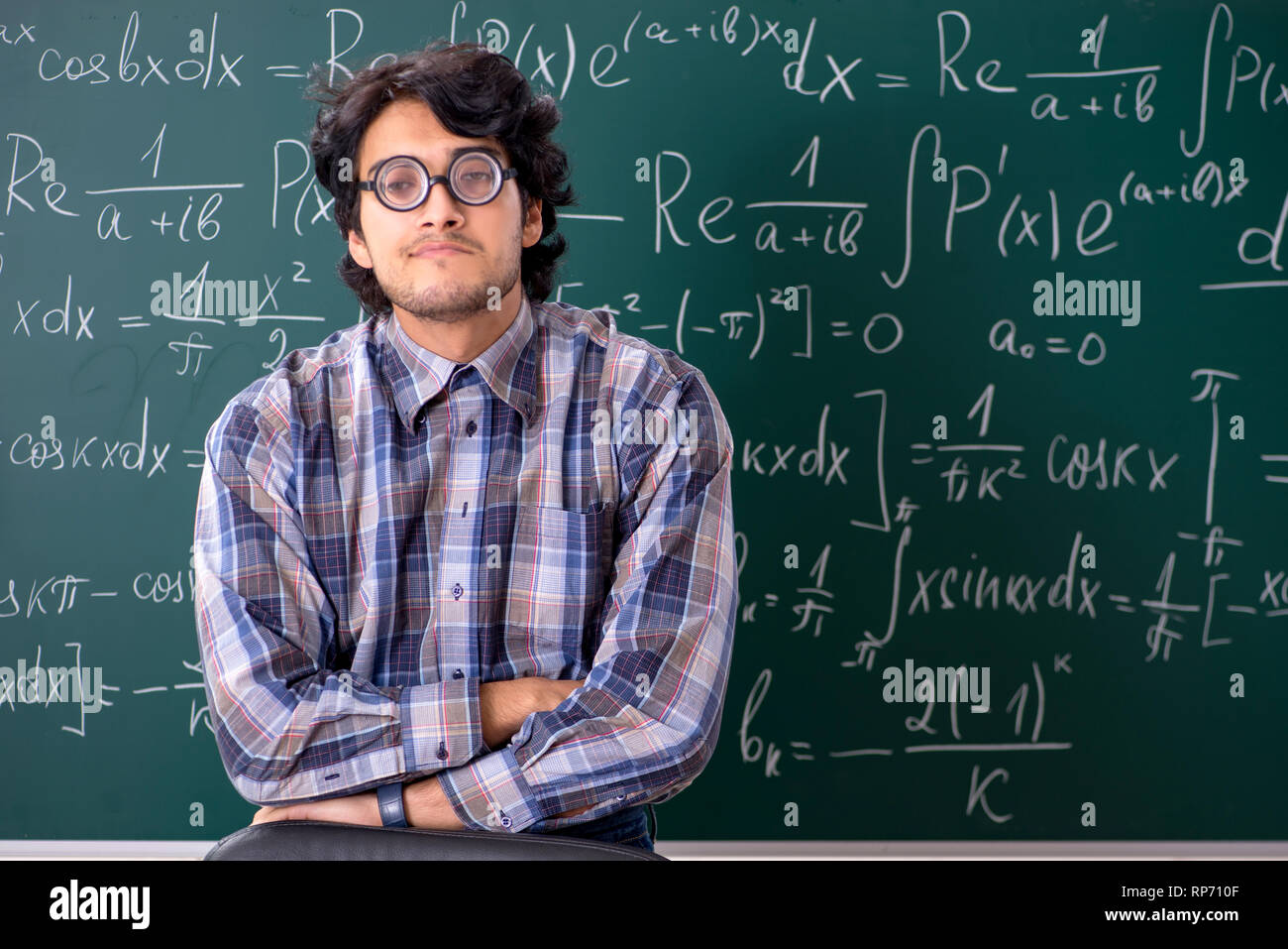 Funny male math teacher in the classroom Stock Photo - Alamy