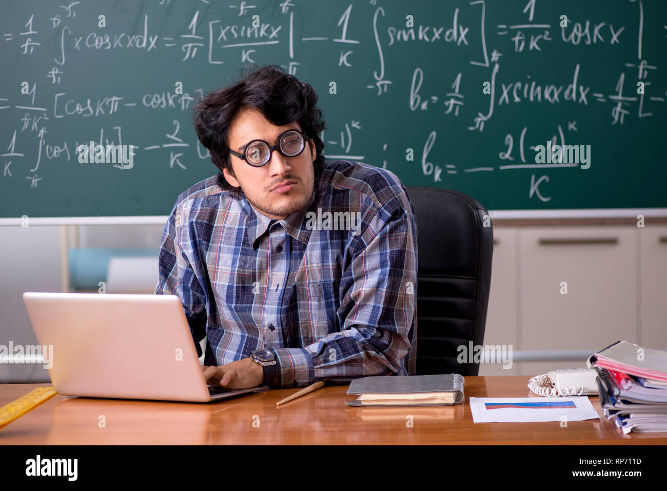 Funny male math teacher in the classroom Stock Photo - Alamy