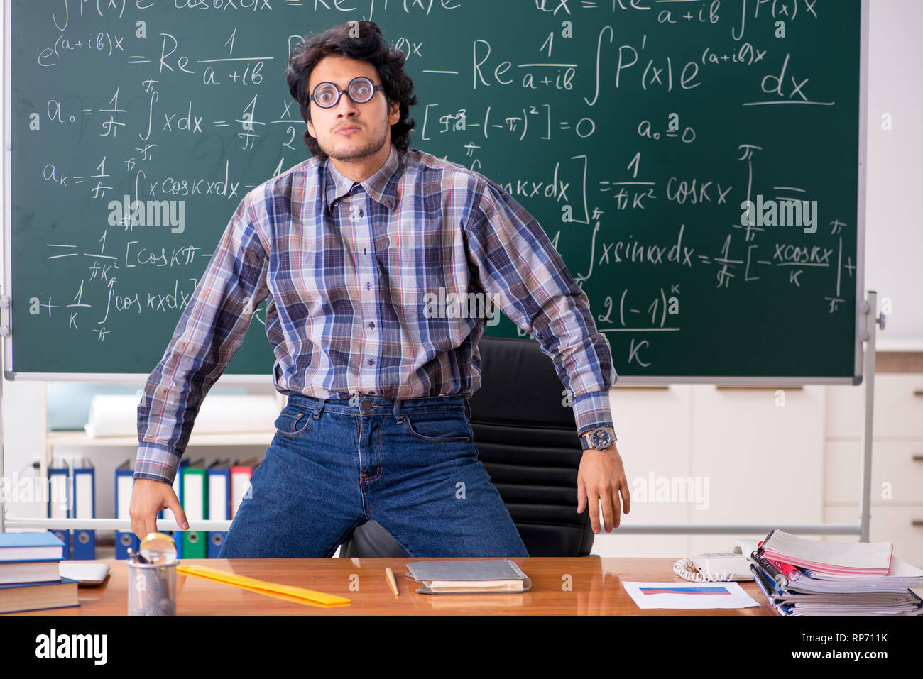 Funny male math teacher in the classroom Stock Photo - Alamy