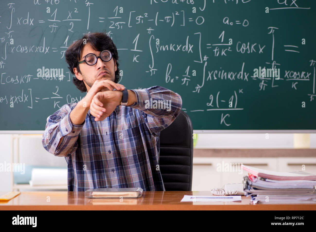 Funny male math teacher in the classroom Stock Photo - Alamy