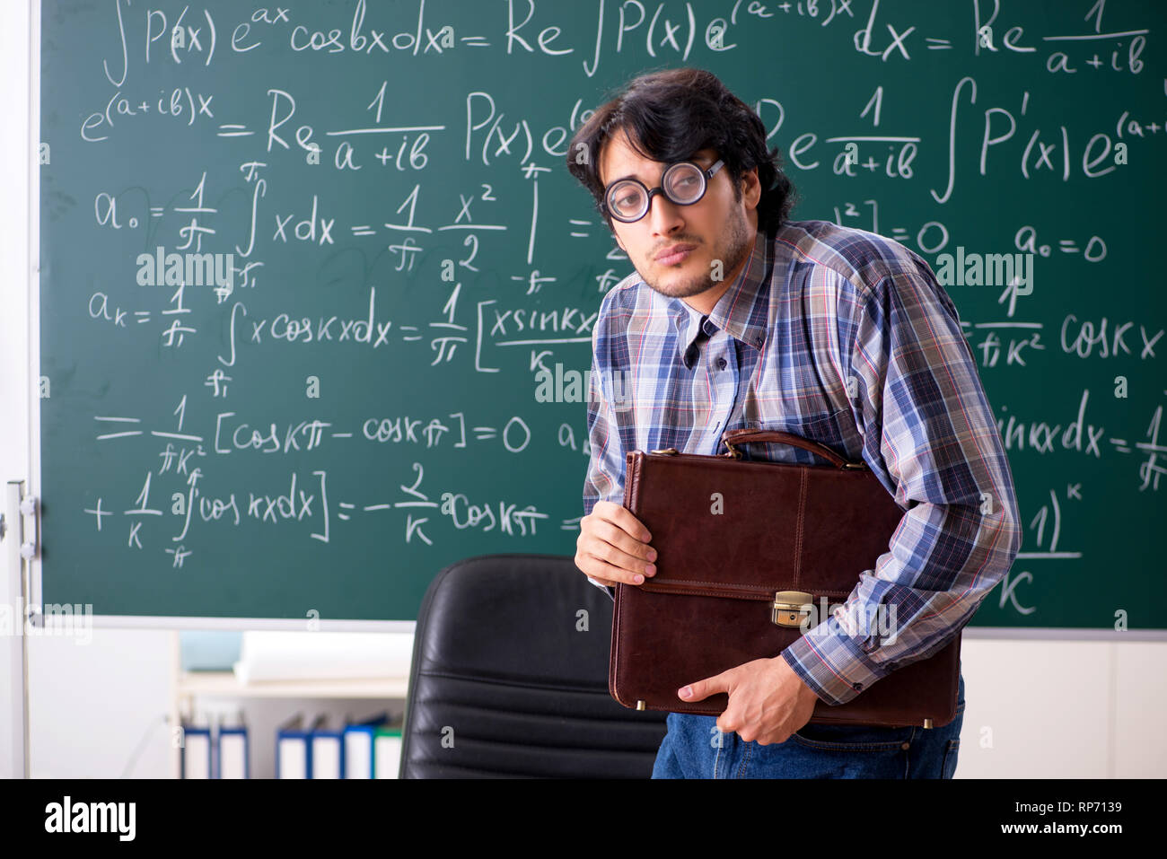 Funny male math teacher in the classroom Stock Photo - Alamy
