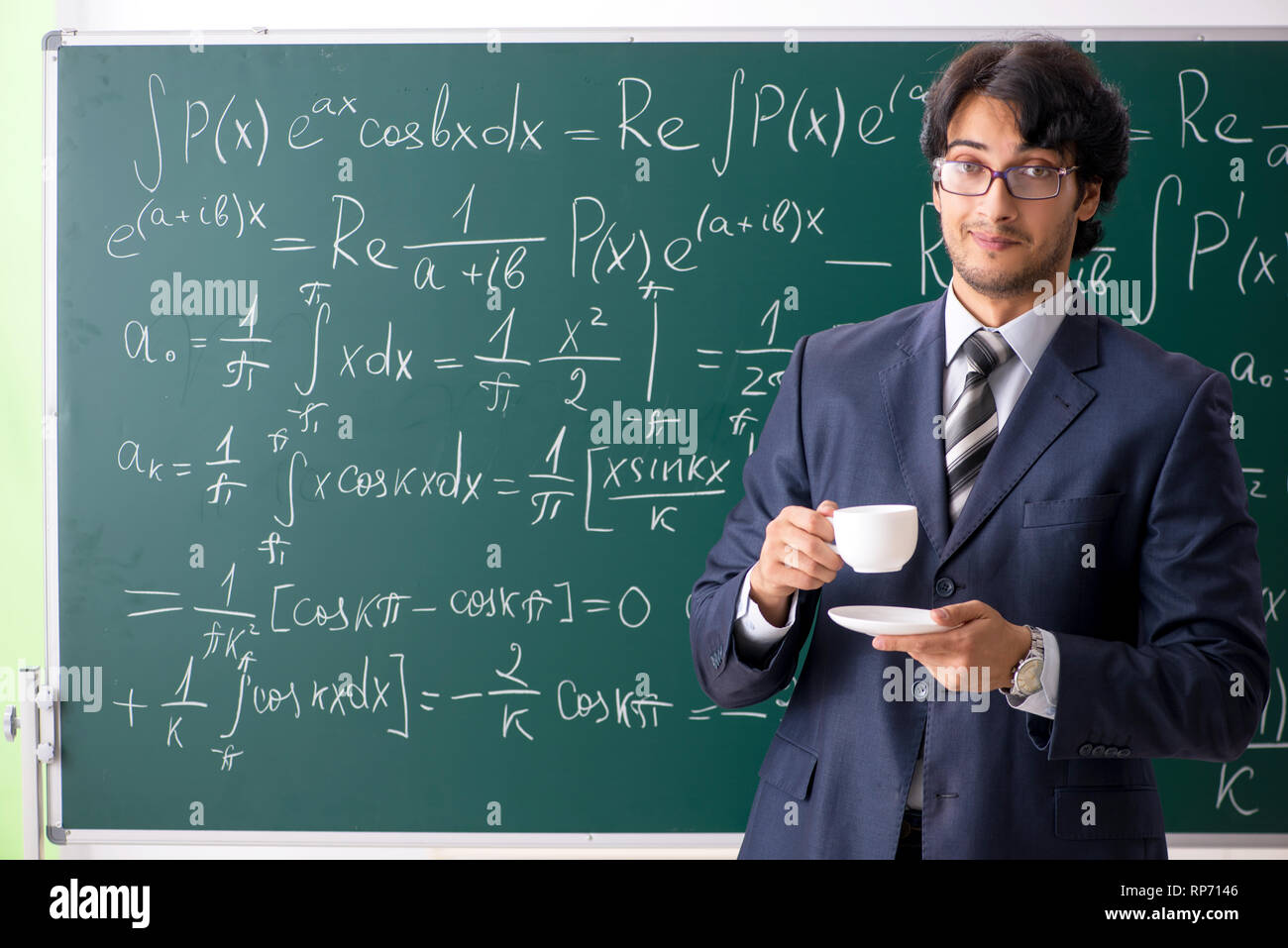 Young male math teacher in classroom Stock Photo - Alamy