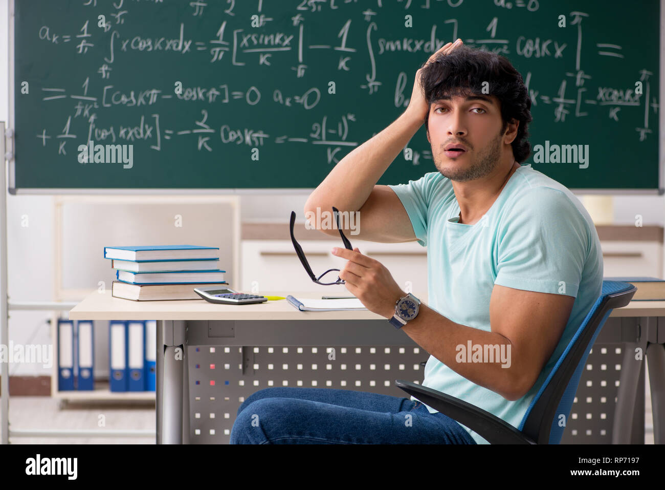 Young male student mathematician in front of chalkboard Stock Photo - Alamy