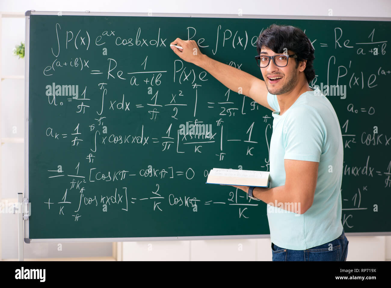 Young male student mathematician in front of chalkboard Stock Photo - Alamy