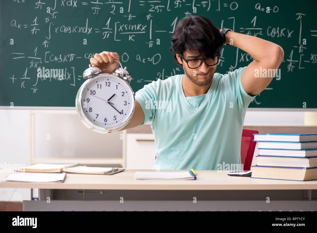 Young male student mathematician in front of chalkboard Stock Photo - Alamy