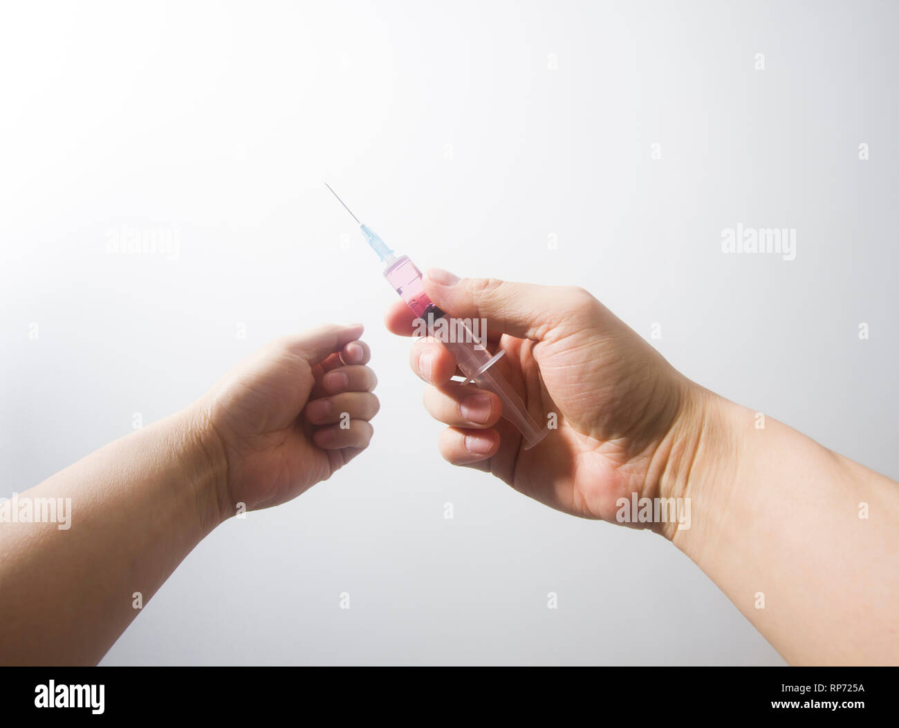 Syringe and arm Stock Photo - Alamy