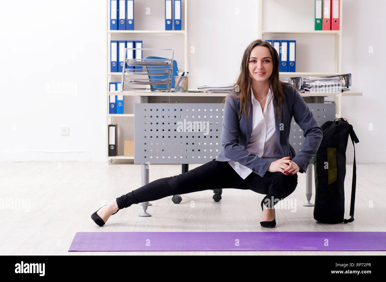 Female employee doing sport exercises in the office Stock Photo - Alamy