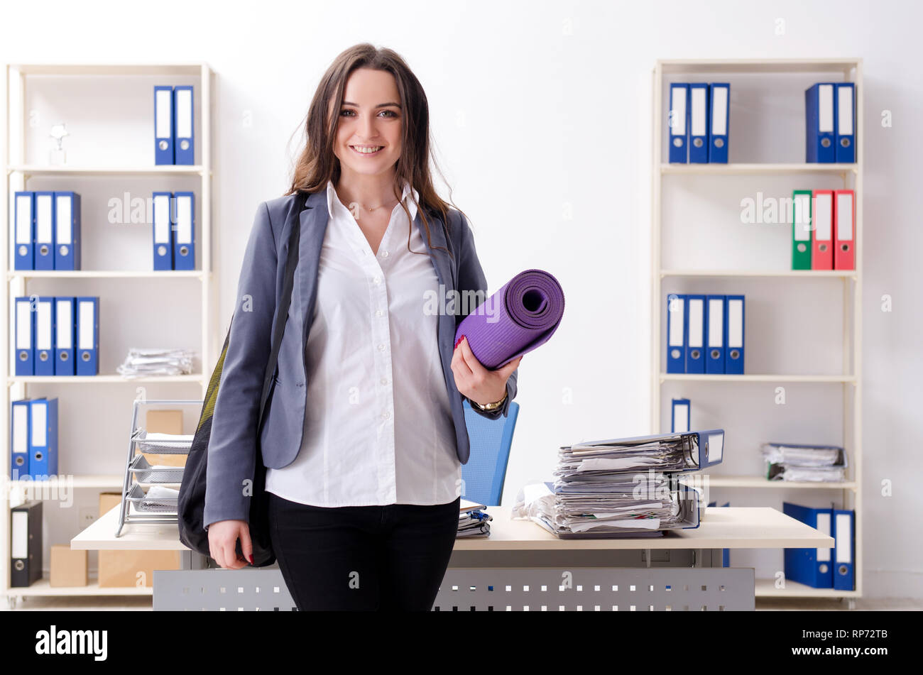 Female employee doing sport exercises in the office Stock Photo - Alamy